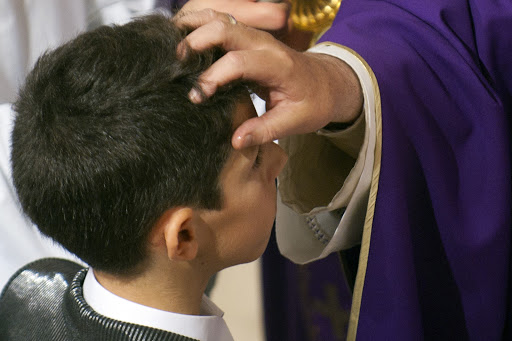 At what age is confirmation received in the Catholic Church?