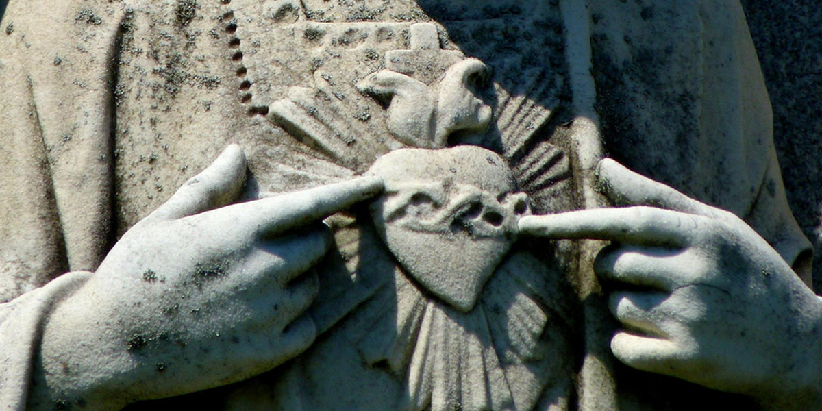 Why is the Sacred Heart of Jesus on fire?