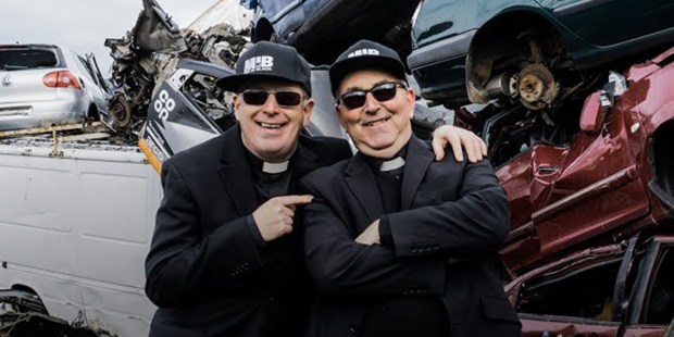 The Men in Black, a Catholic priest and a Protestant minister, rap ...