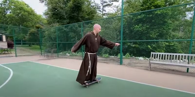 The skateboarding priest with the “holy graphics” on his board