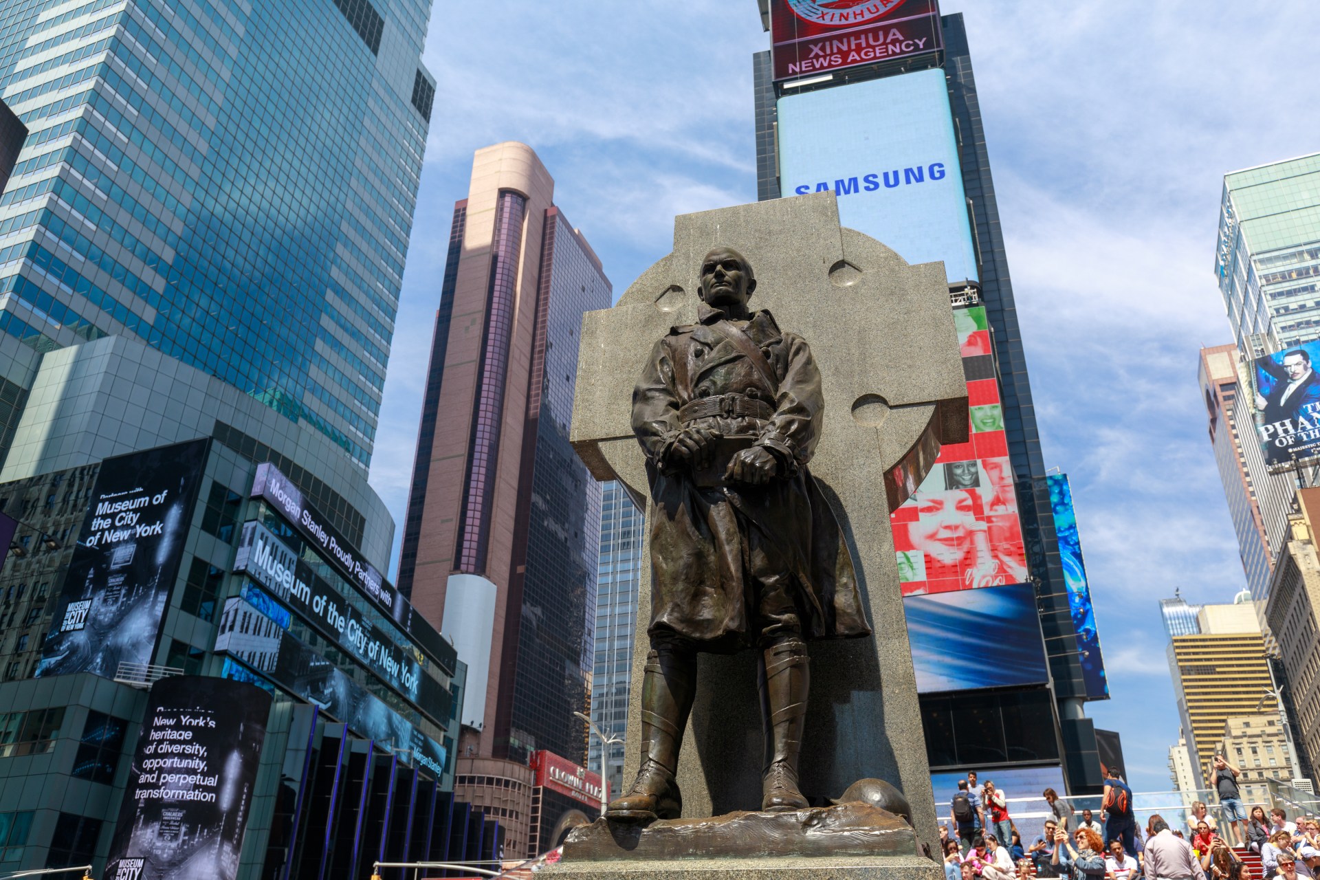 Why is there a statue of a Catholic priest in NYC's Times Square?