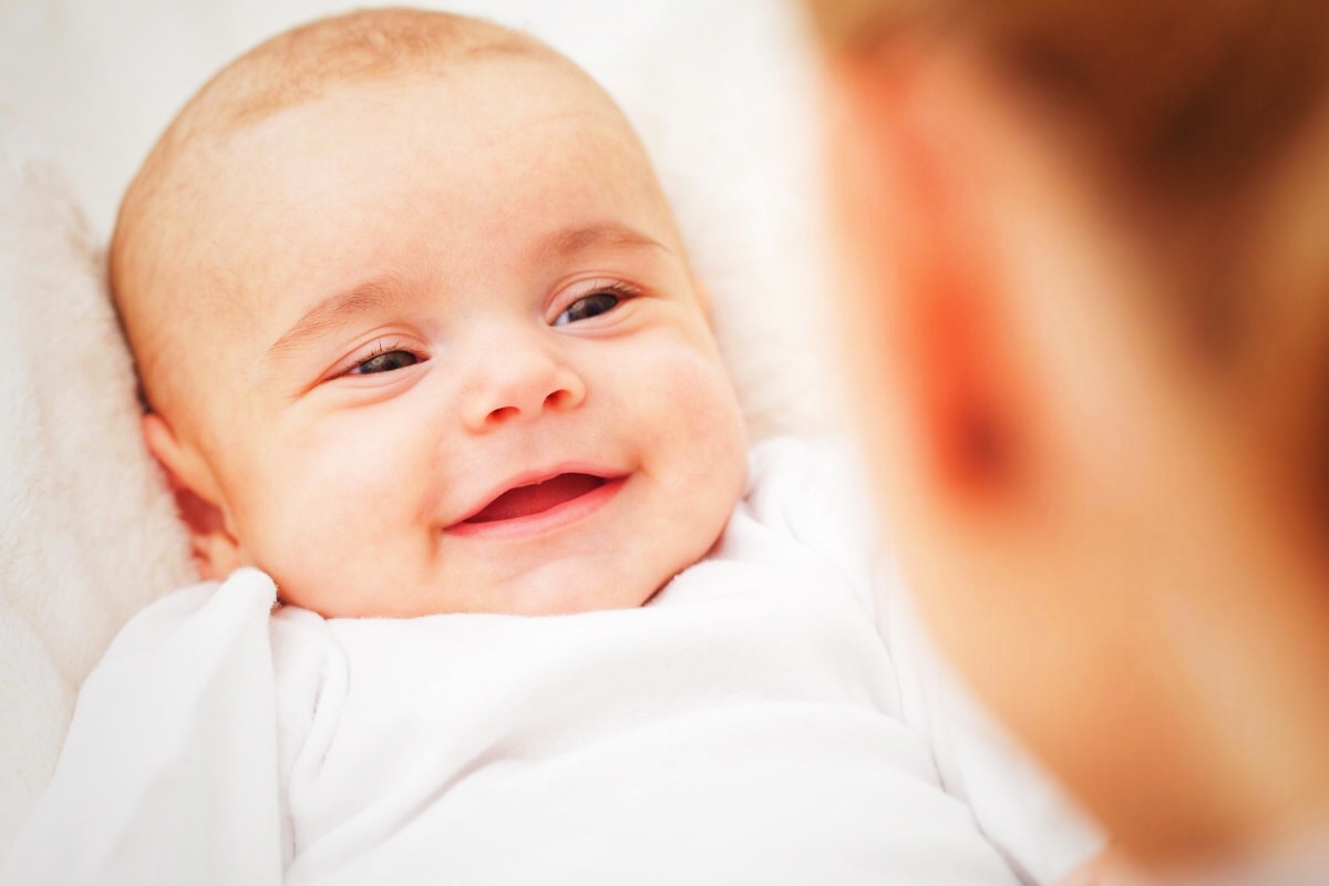 Newborn Baby Smiling With Mom