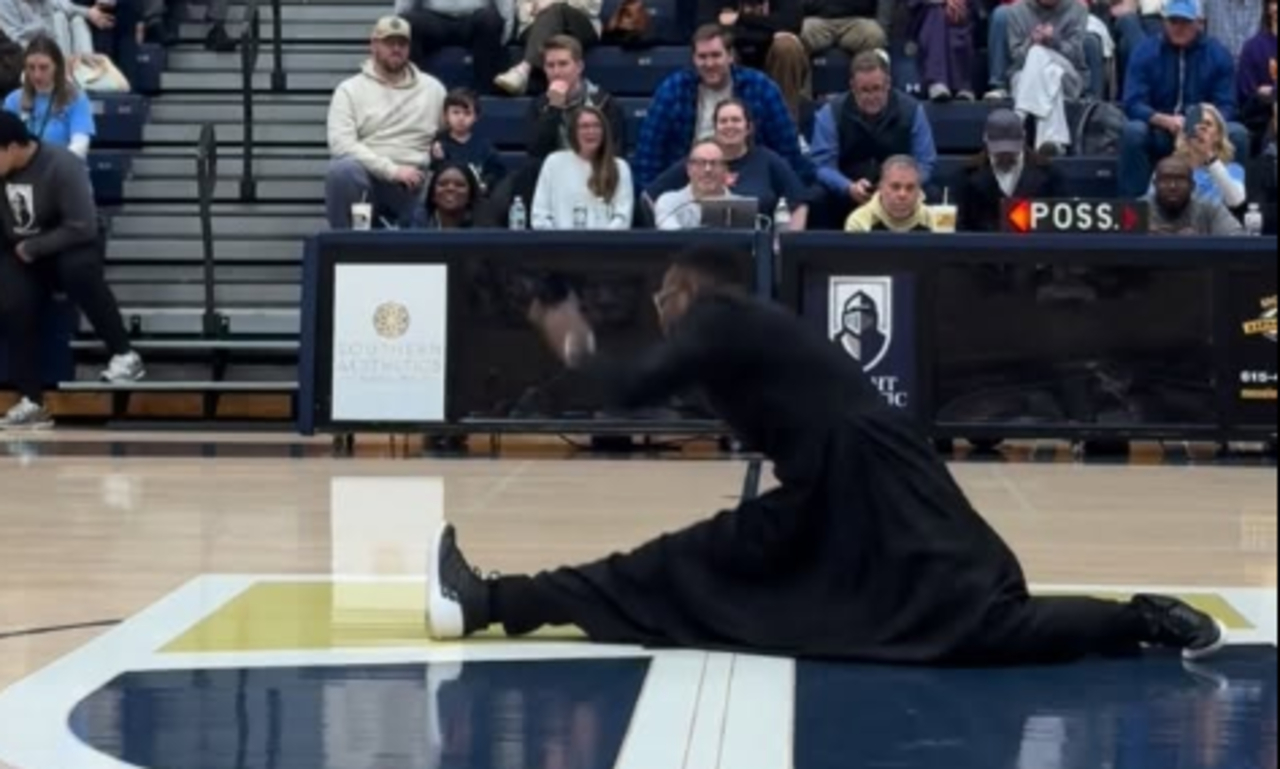 Priest brings down the house with dance at basketball game