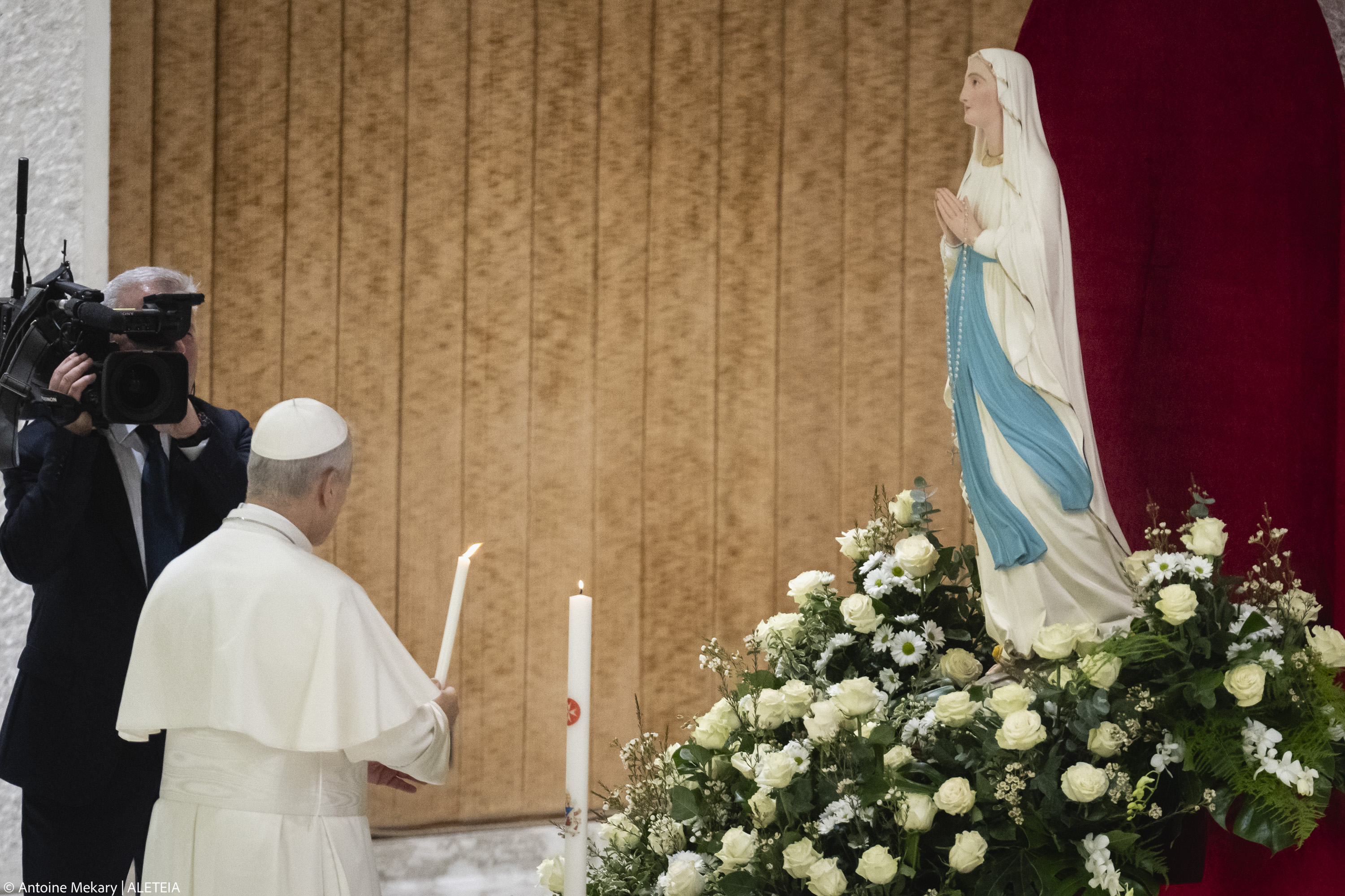 Pope lights candle for the sick before Our Lady of Lourdes